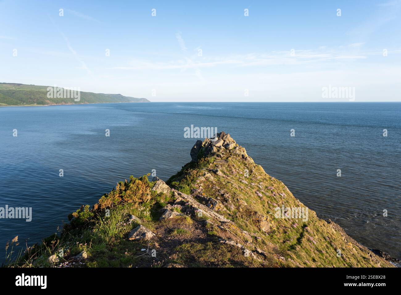 Morning light shines on the cliffs of Hurlstone Point and Portlock Bay ...