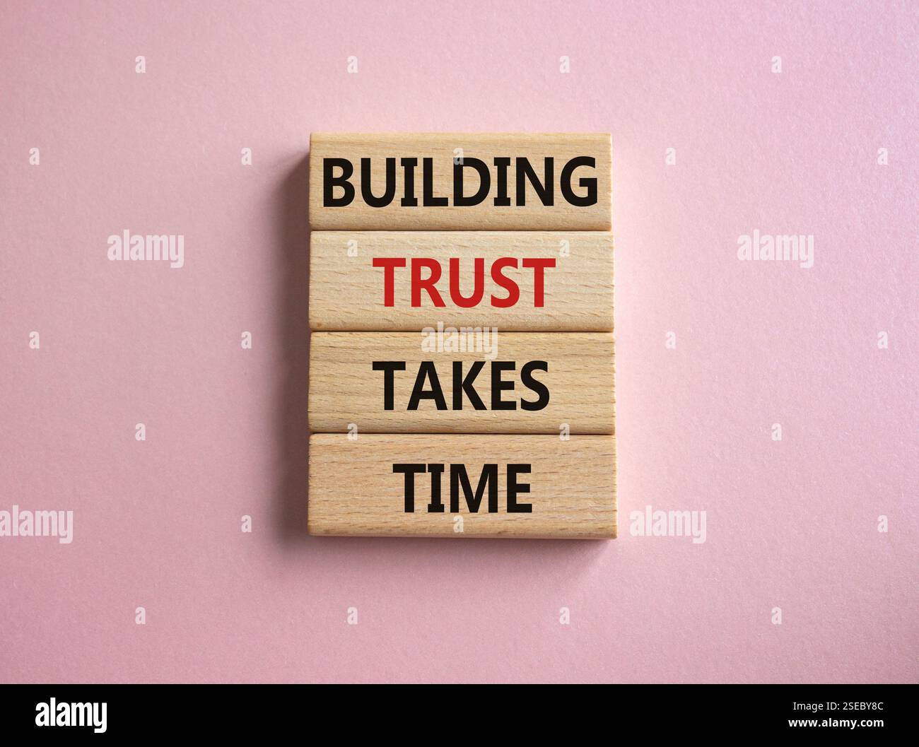 Building Trust takes Time symbol. Wooden blocks with words Building ...