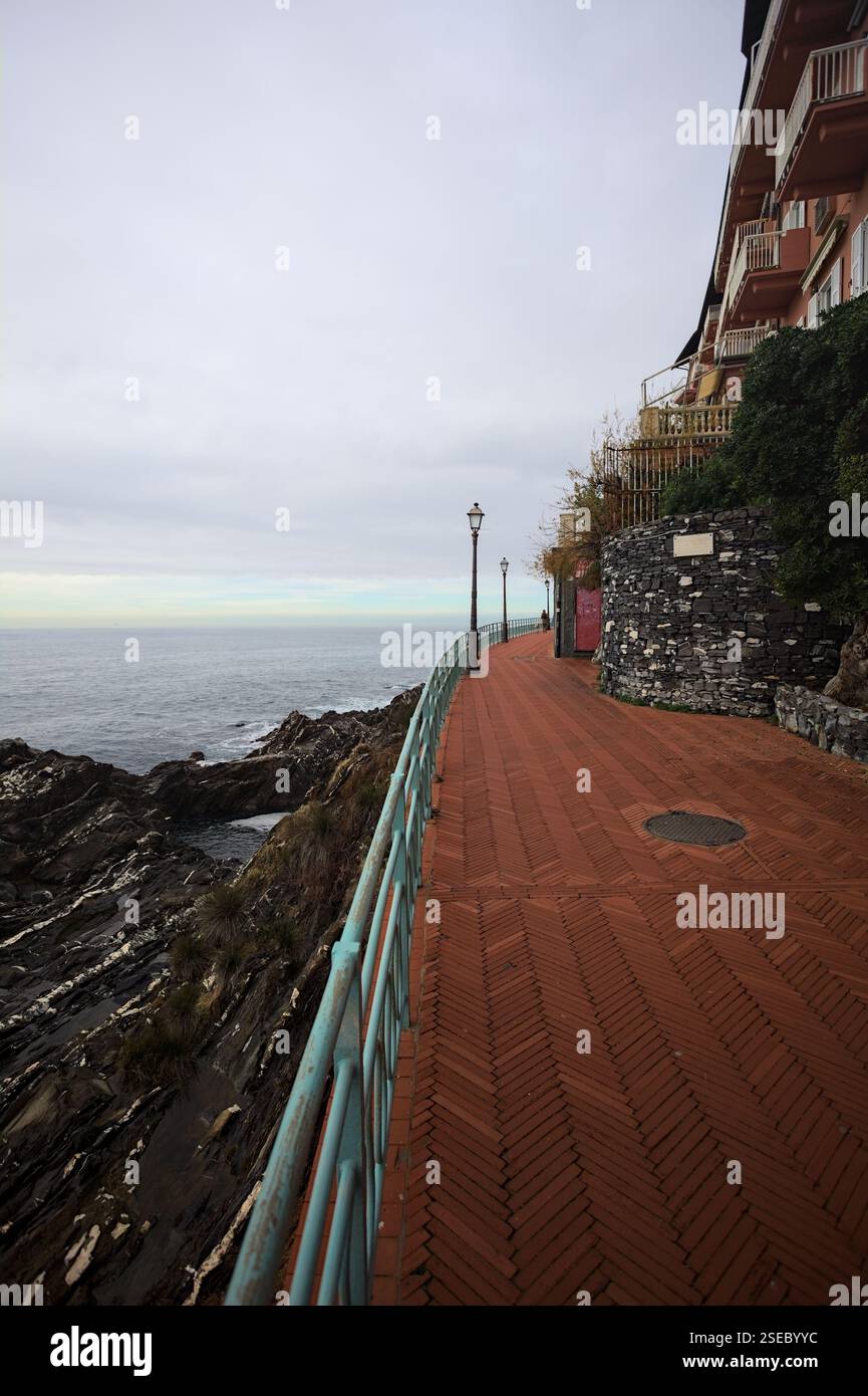 Promenade with street lights on a cliff with trees and buildings by its ...