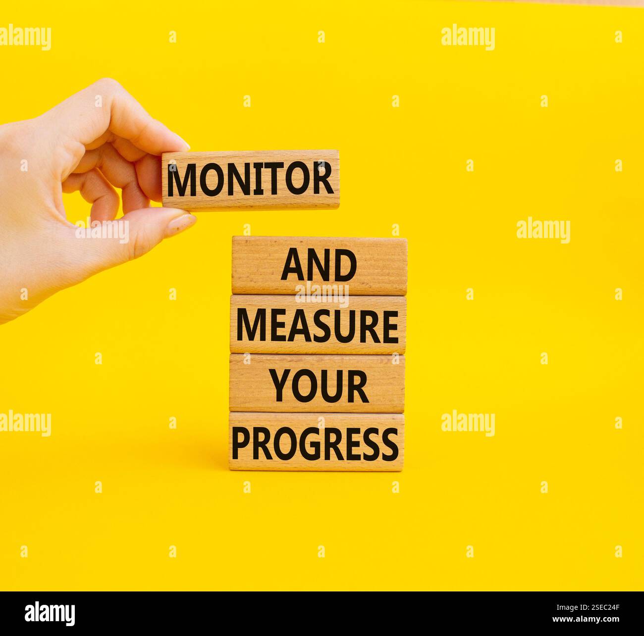 Monitor and Measure your Progress symbol. Wooden blocks with words ...
