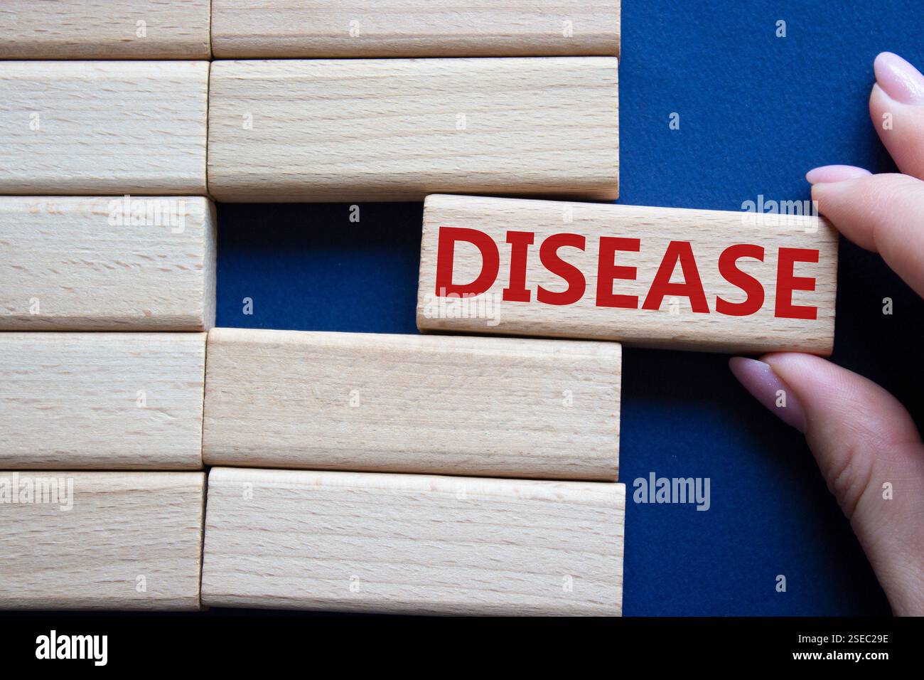 Disease symbol. Concept word Disease on wooden blocks. Doctor hand ...