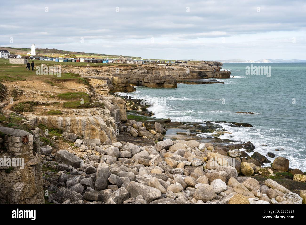 People walk past old quarry workings on the Jurassic Coast path on ...