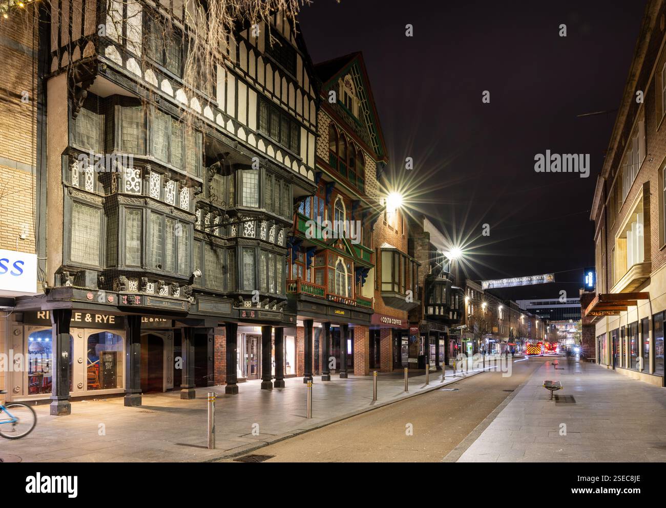 Shops and offices, including traditional Tudor timber facades, line the ...