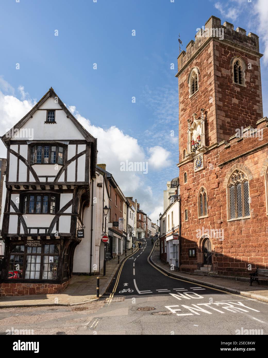 Sun shines on St Mary's Church and West Street in Exeter, Devon Stock ...