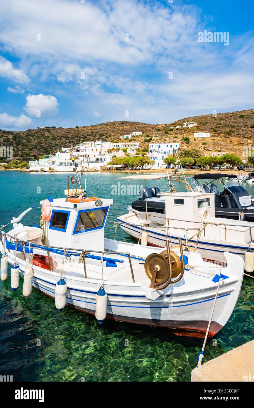 Typical Greek fishing boats anchoring in Faros port and mountains in ...