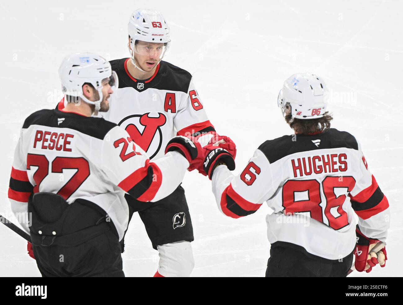 New Jersey Devils' Jack Hughes (86) celebrates with teammates Jesper ...