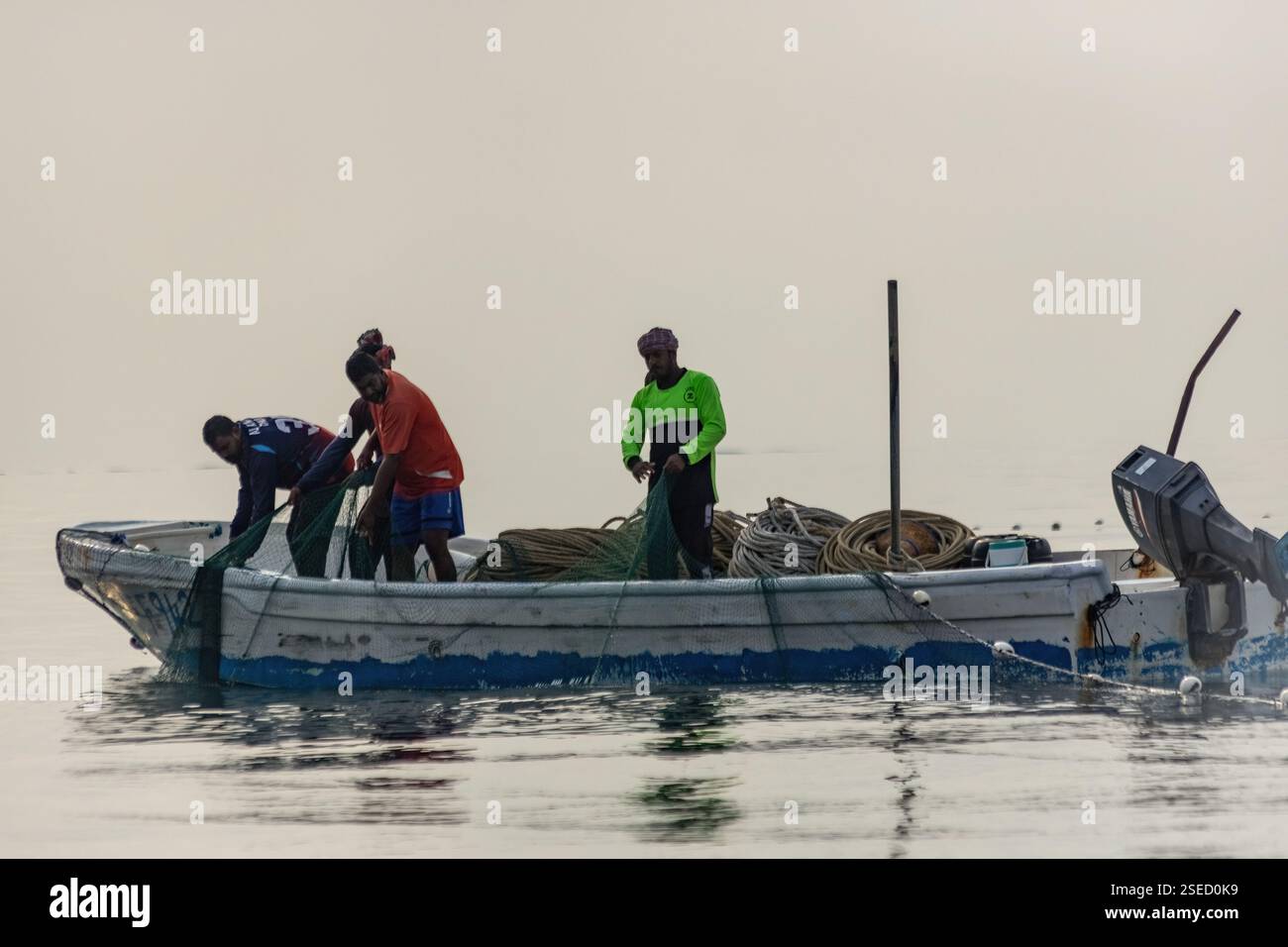 Fisherman catching the fish with the nets fishing boats in the sea ...