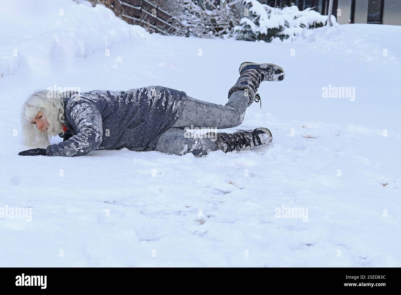 Risk of slipping on a slippery road in winter. A woman slipped and fell ...