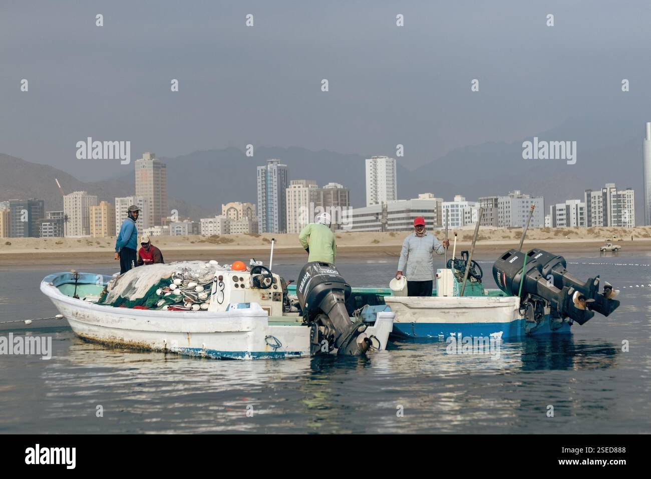Fisherman catching the fish with the nets fishing boats in the sea ...