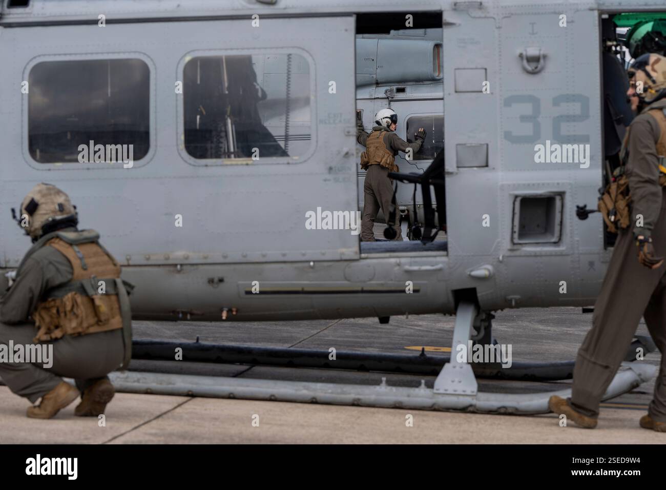 Members of Marine Light Attack Squadron 773 conduct pre-flight checks ...