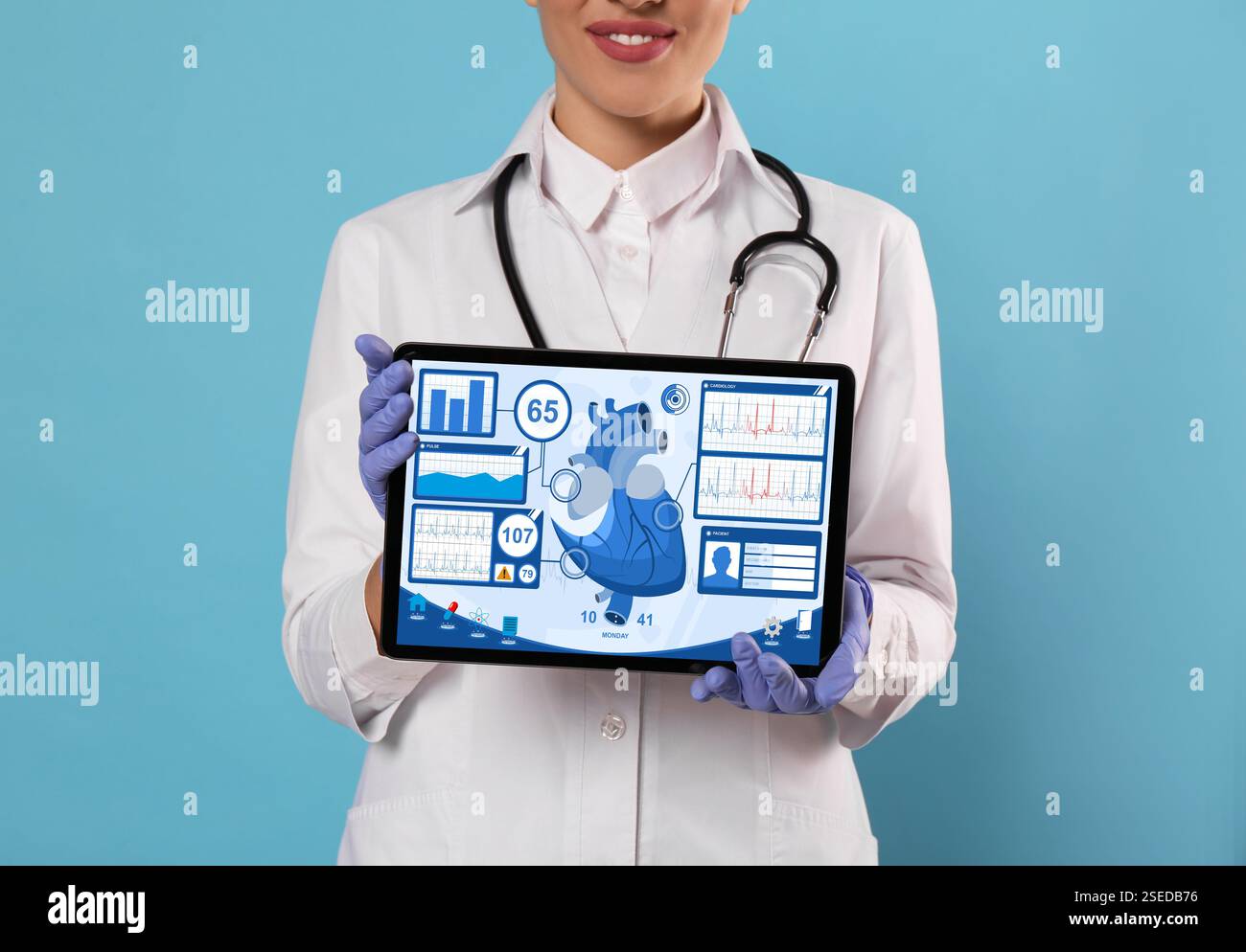 Cardiology. Doctor holding tablet computer with data on screen against ...