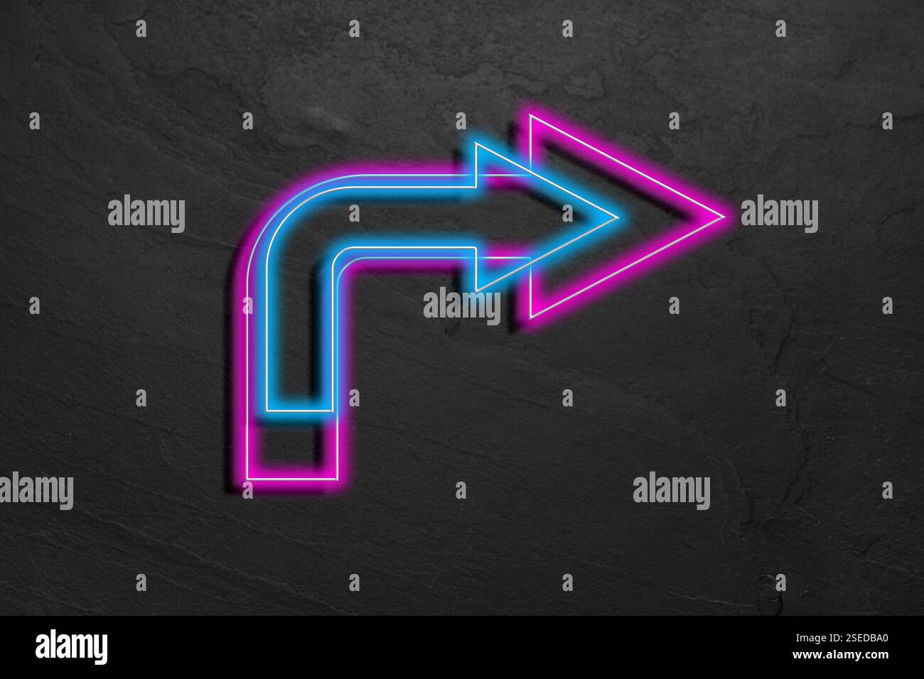 Bright neon arrow-shaped pointer on grey textured wall Stock Photo - Alamy