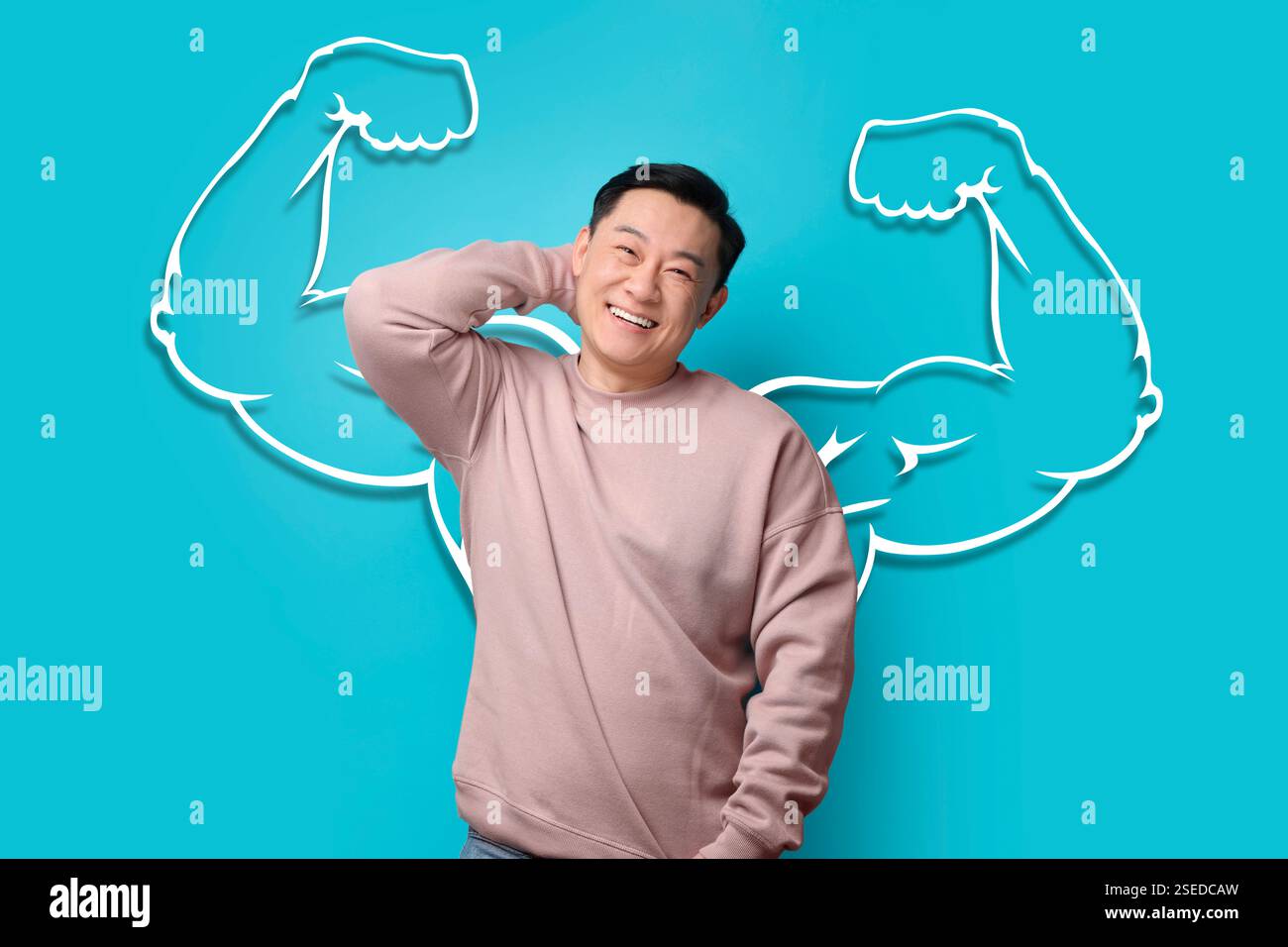 Happy man with drawing of strong arms behind him on light blue ...