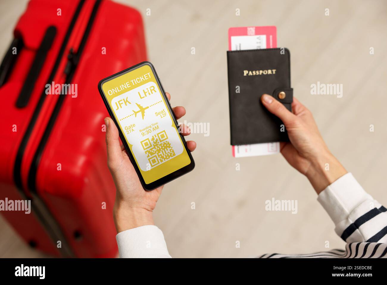 Tourist with passport, flight ticket and mobile phone indoors, above ...