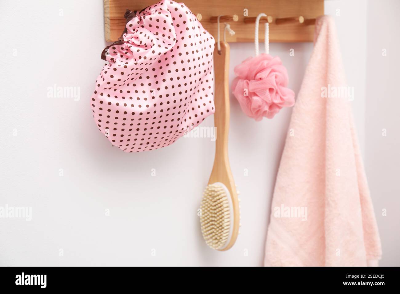 Shower cap, brush, mesh sponge and towel indoors Stock Photo - Alamy