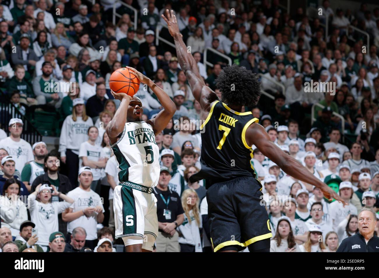 Michigan State guard Tre Holloman (5), left, shoots against Oregon ...