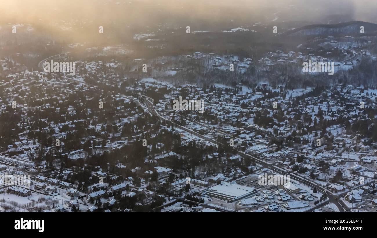 An aerial view showcases a small Canadian town blanketed in fresh snow ...
