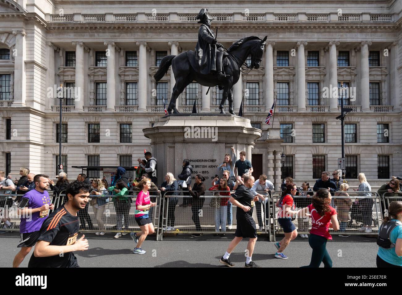 Runners in the London Marathon pass the statue of the Commander-in ...