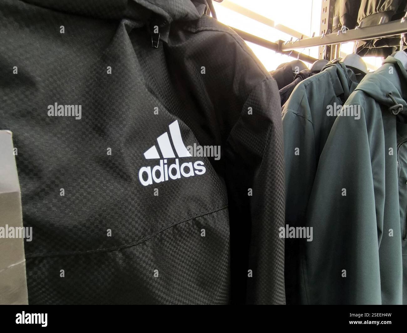 Adidas jackets displayed on clothing rack in retail store Stock Photo ...