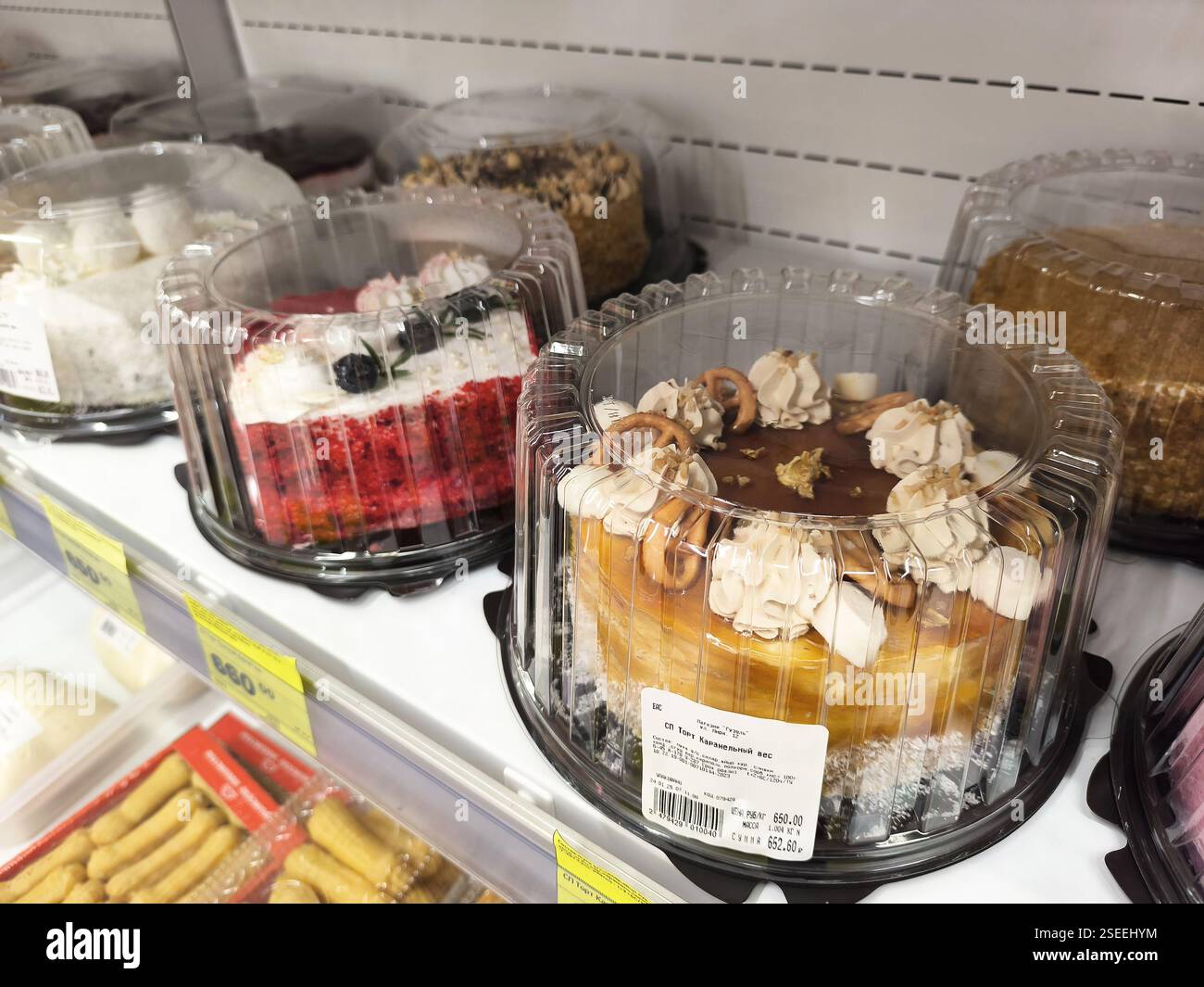 Assorted bakery cakes in plastic containers on store shelf Stock Photo ...