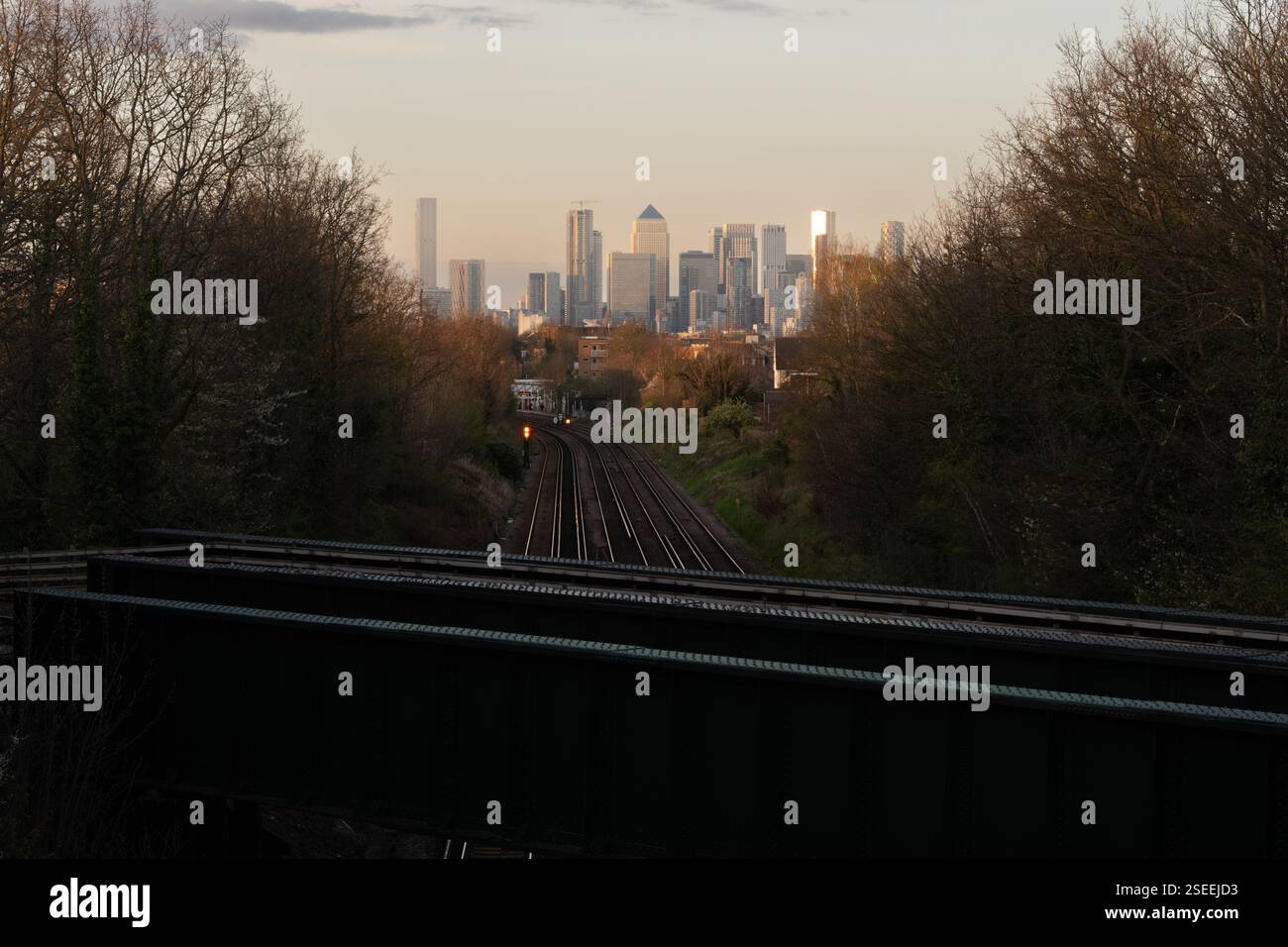 Train tracks near Canary Wharf, London, UK. A train passes through the ...