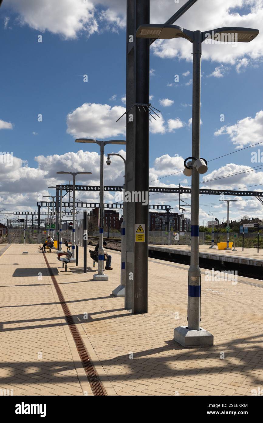 Train station platform at Brent Cross West , London. Passengers wait on ...