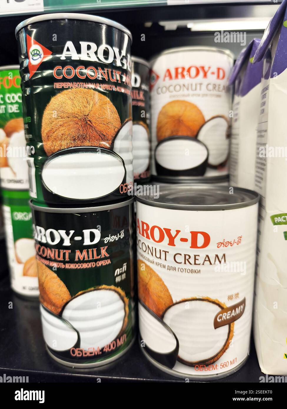 Coconut milk and cream cans on store shelf Stock Photo - Alamy