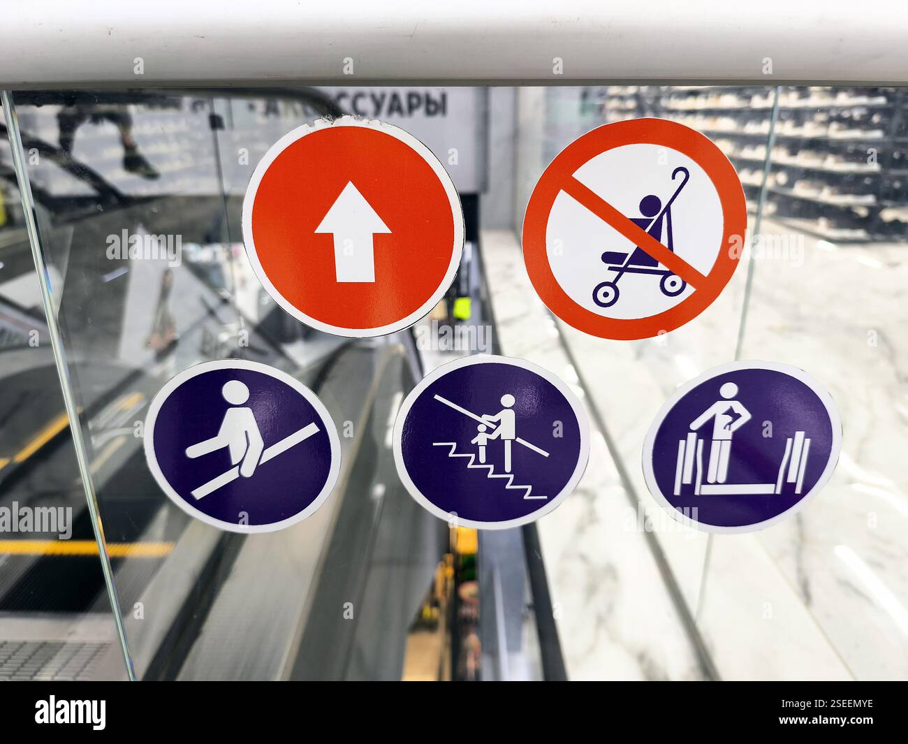 Escalator safety signs in shopping mall with various warnings and ...
