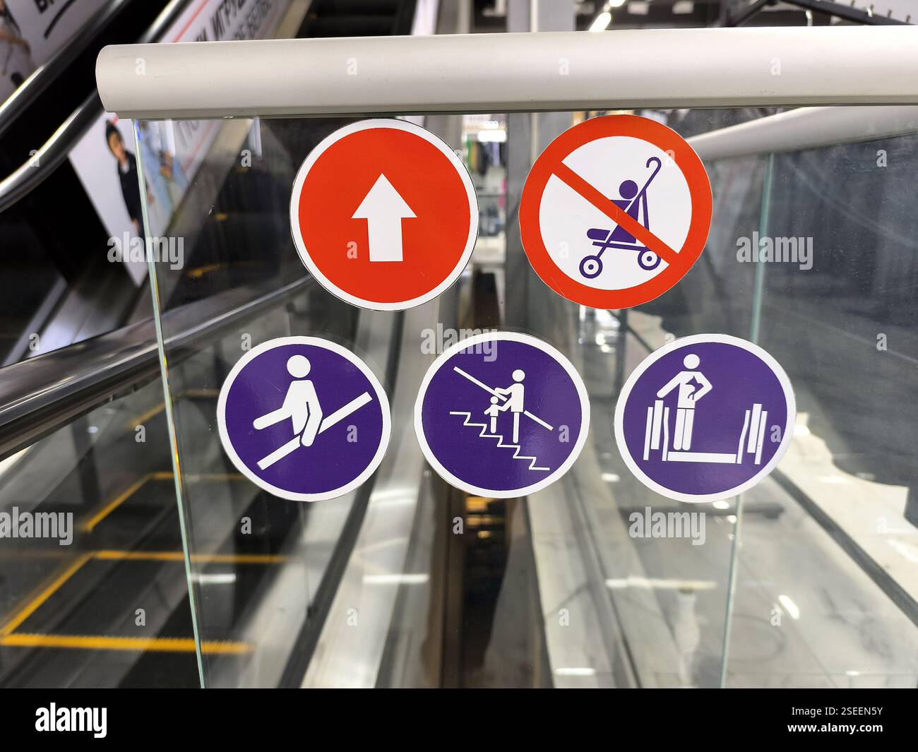 Escalator safety signs indicating direction and prohibited strollers ...