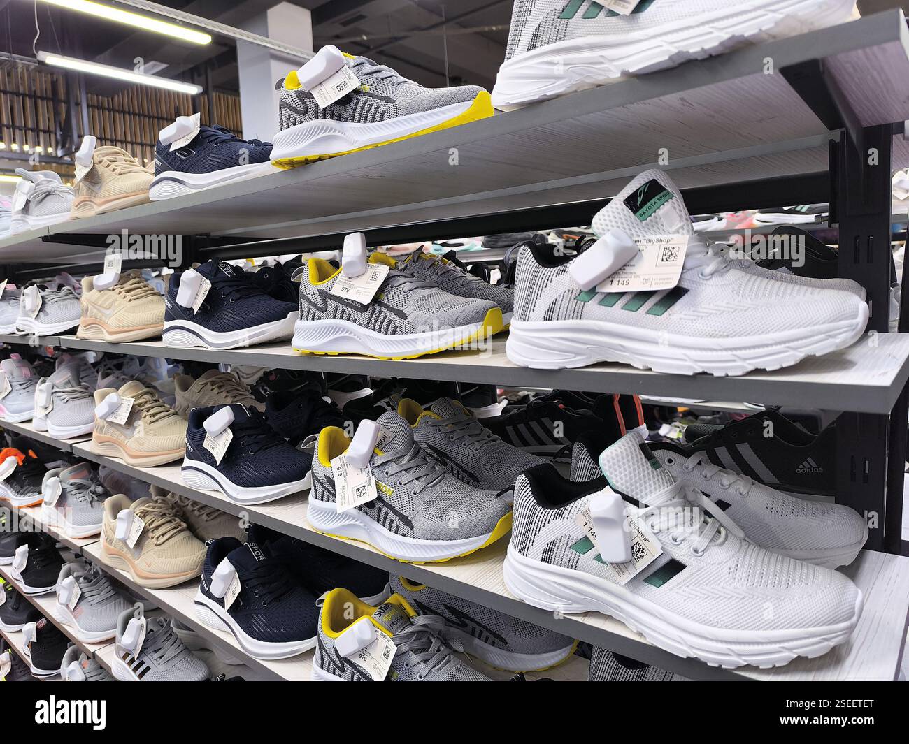 Variety of athletic sneakers on display in shoe store aisle Stock Photo ...