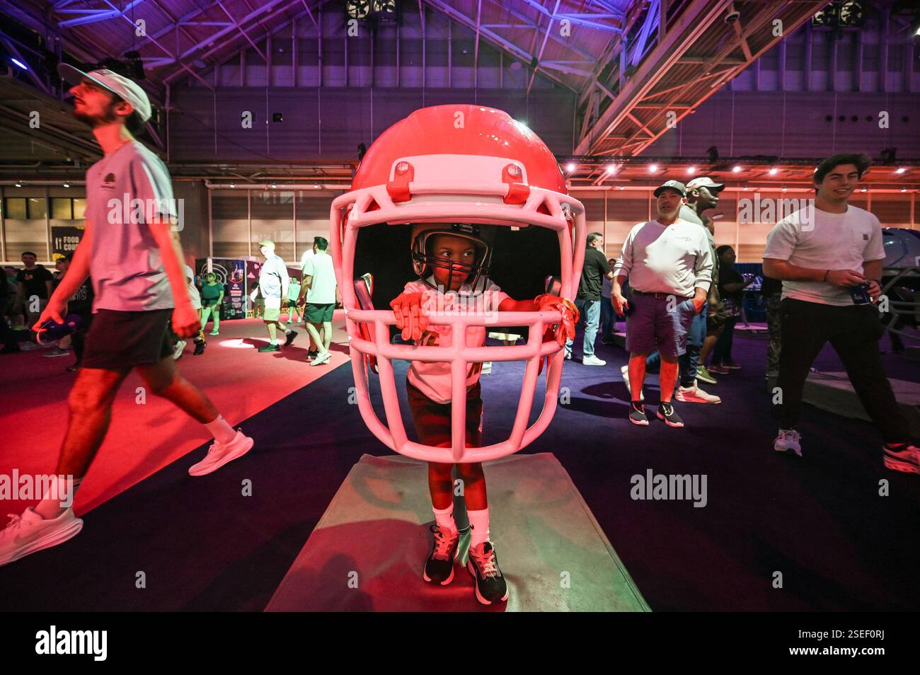 People take photos near oversized football helmets in the NFL Super ...