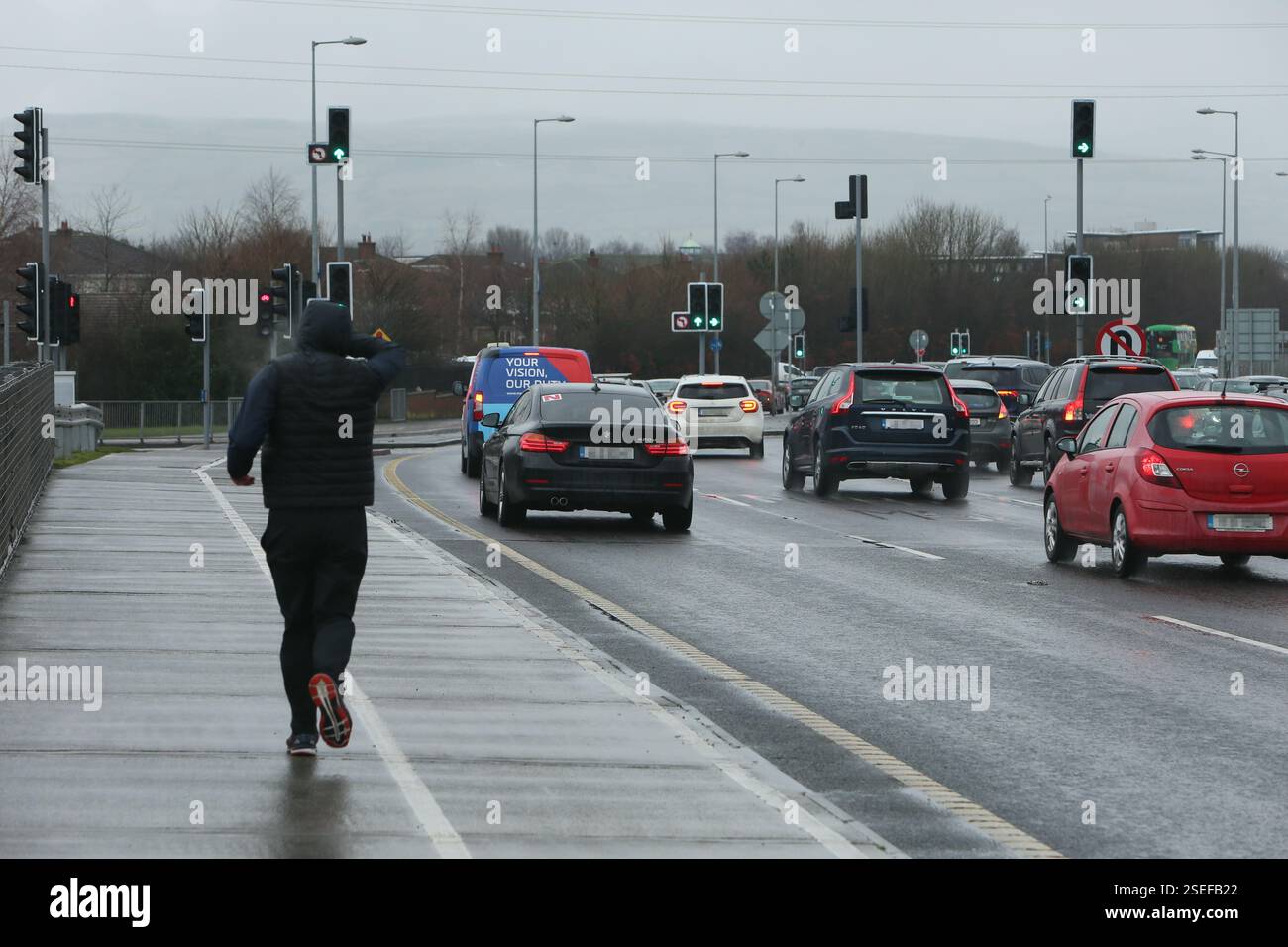 Firhouse, Dublin, Ireland - 08th February 2025 - a man walks across the ...