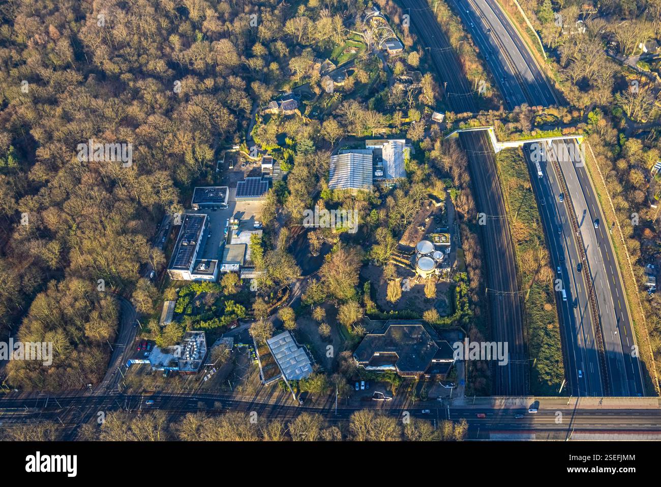Aerial view, zoo in the forest with green bridge, round elephant house ...