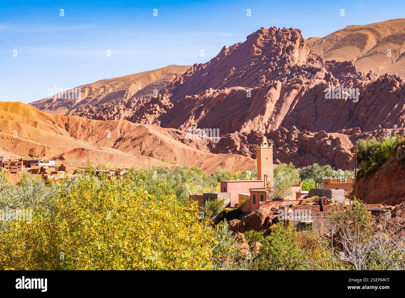 Traditional village with clay houses and mosque minaret tower in ...