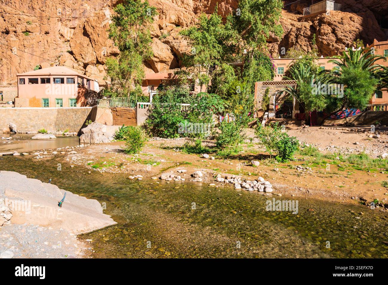 River in Dades Gorge canyon with houses and rocks in background ...