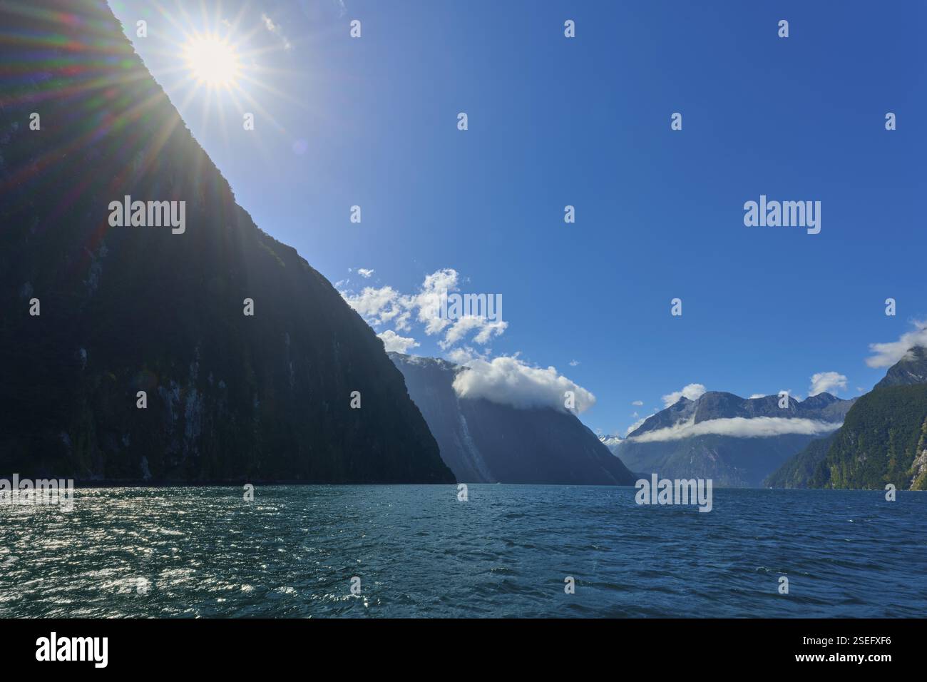 Sunny scene with blue waters and dramatic mountain ranges, summer ...