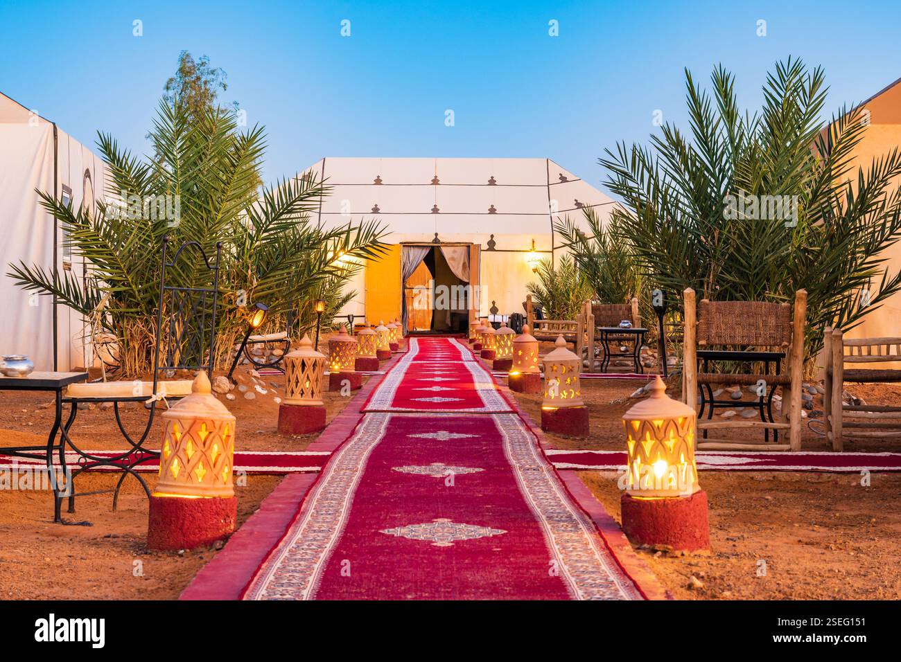 Luxury tent camp illuminated with fire lamps at Erg Chebbi Sahara ...
