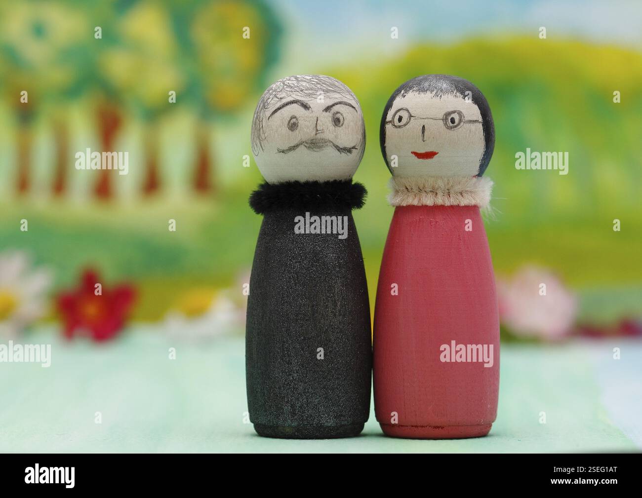 Funny painted wooden cone man and woman in front of a colourful painted ...