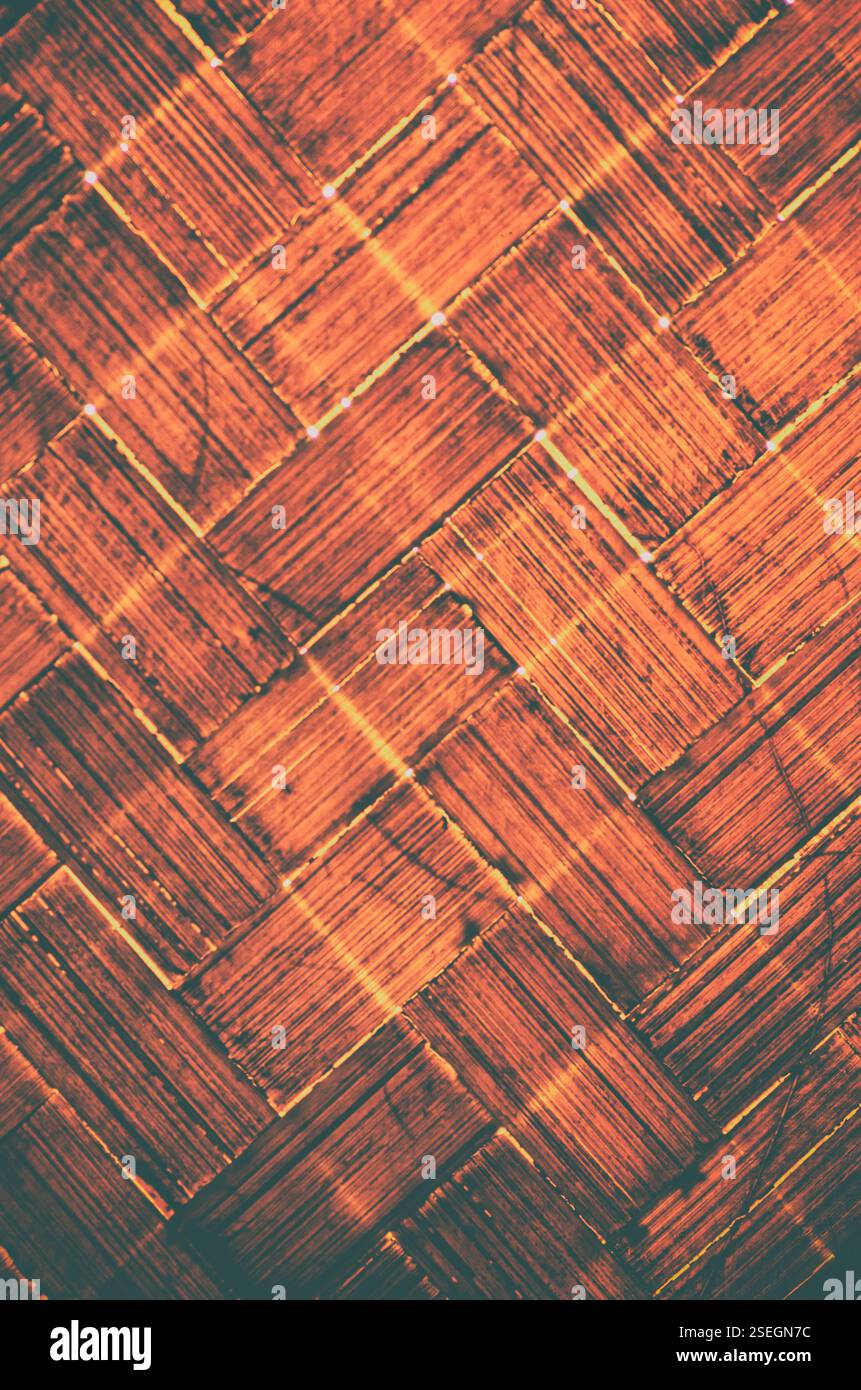 Close-up of a warm-toned woven wooden texture with intricate ...