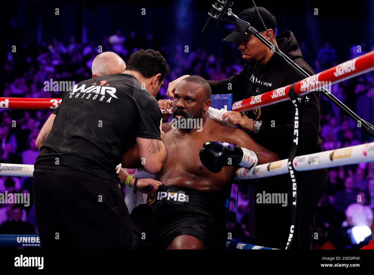 Derek Chisora speaks to his team in-between rounds during their IBF ...