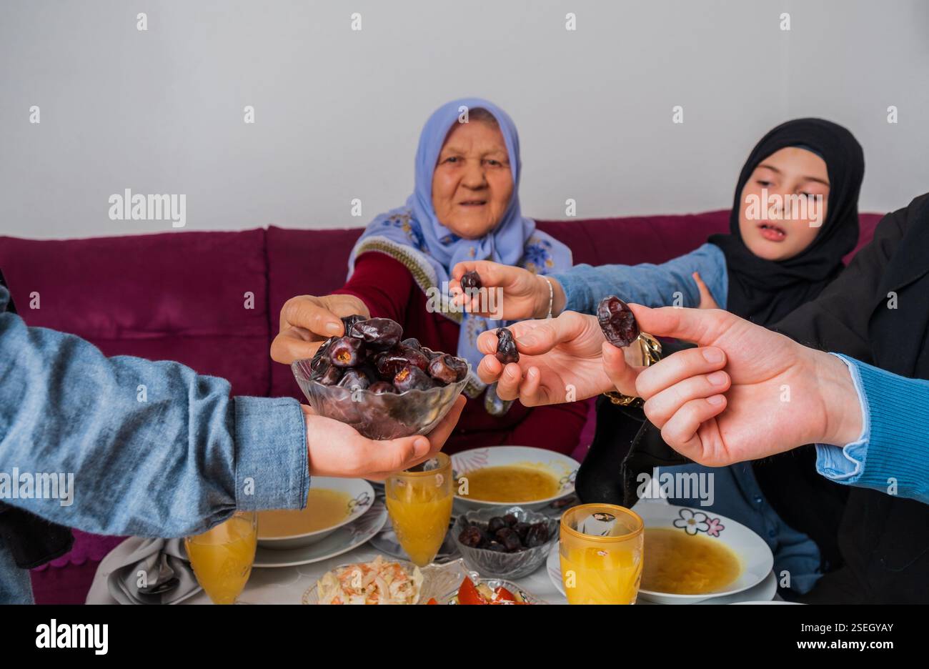 Happy Muslim family having iftar dinner during Ramadan dining table ...