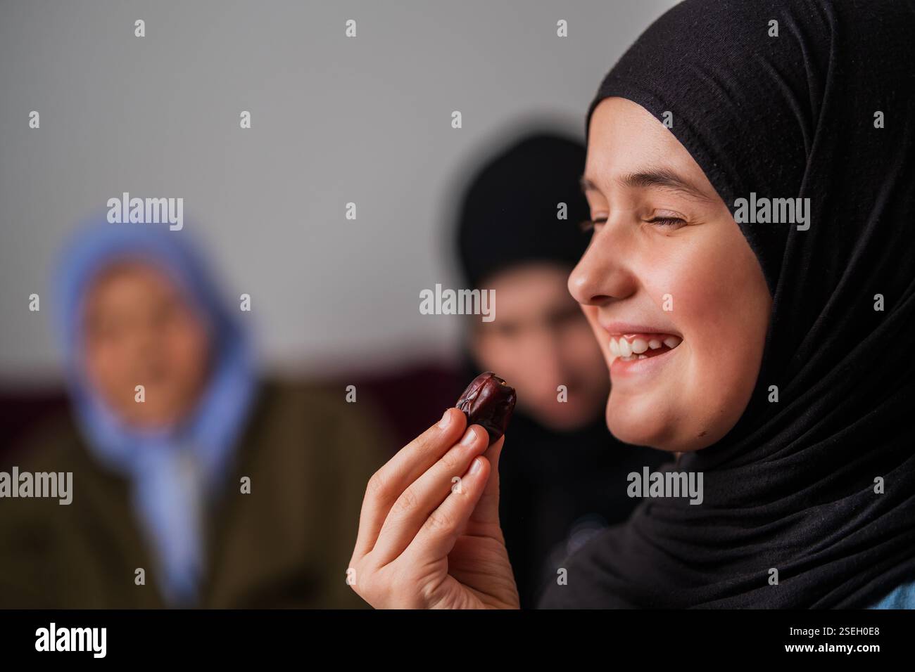 Happy Muslim family having iftar dinner during Ramadan smiling child ...