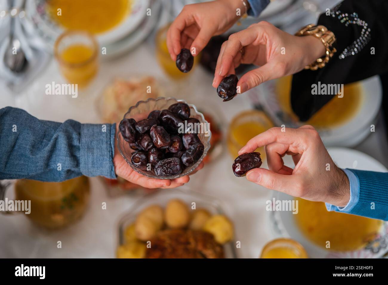Happy Muslim family having iftar dinner to break fasting during Ramadan ...