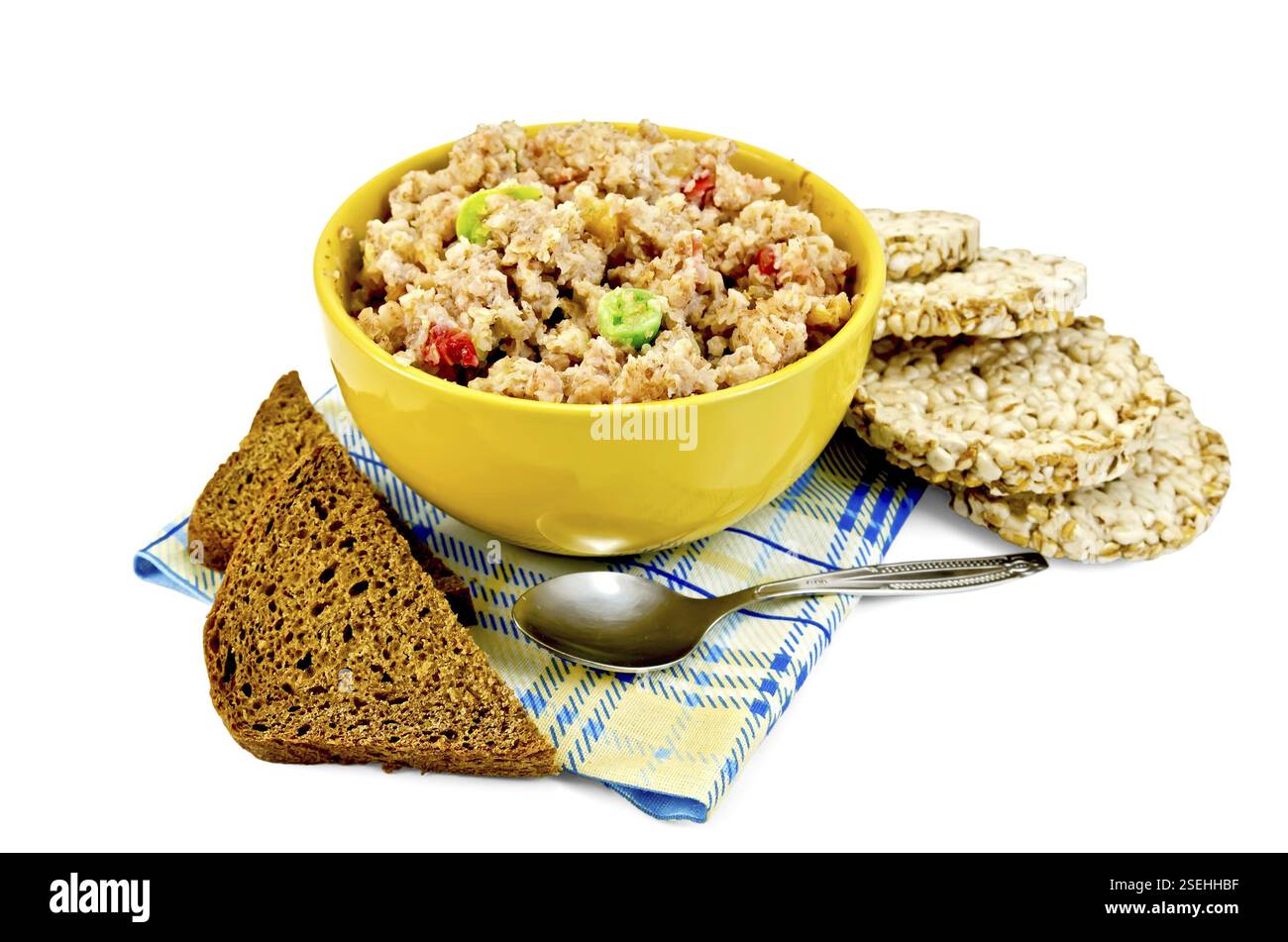 Porridge rye flakes with candied fruit, dark rye bread, spoon on a ...