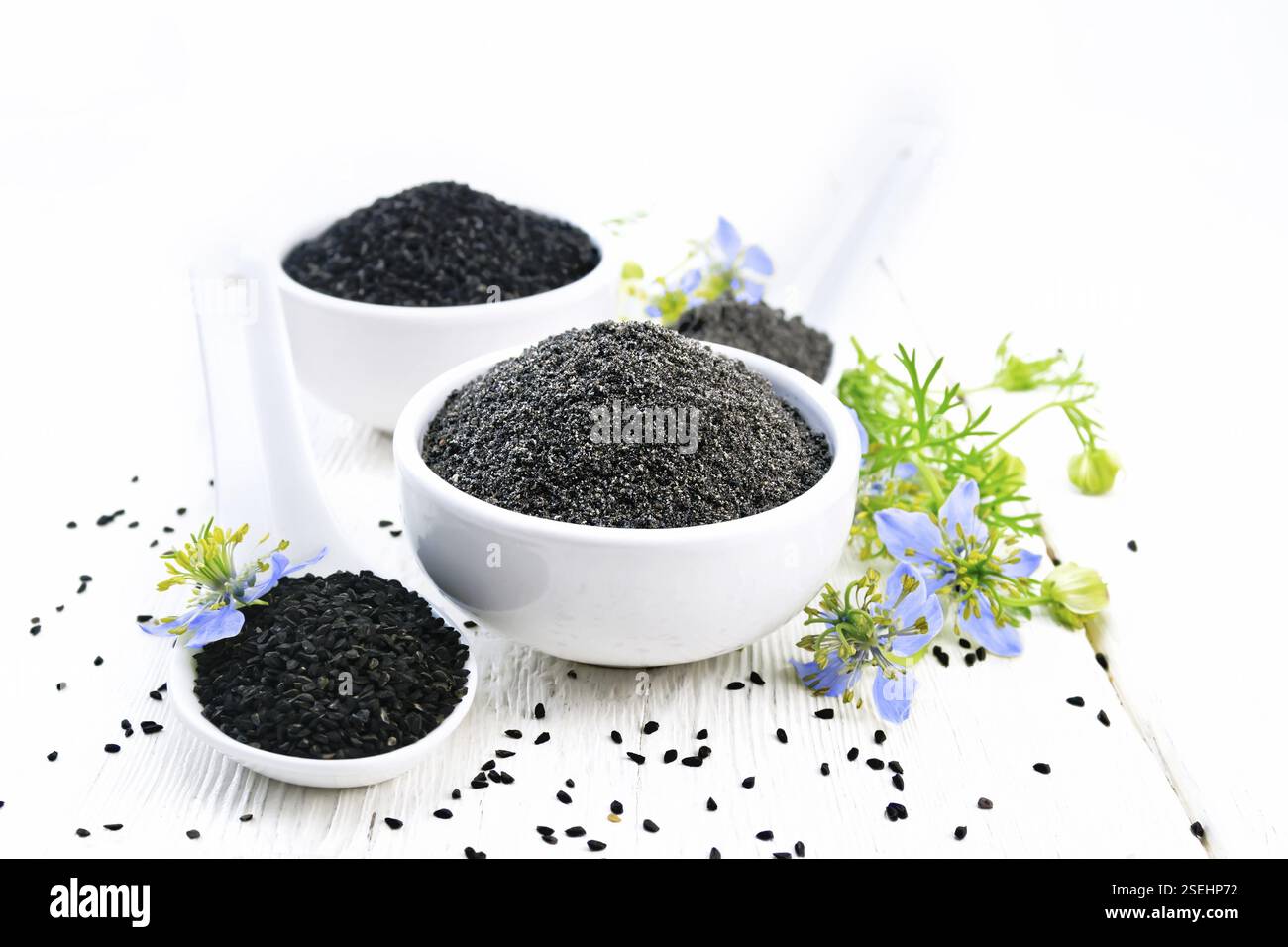 Flour and seeds of black caraway in bowls, sprigs of kalingini with ...