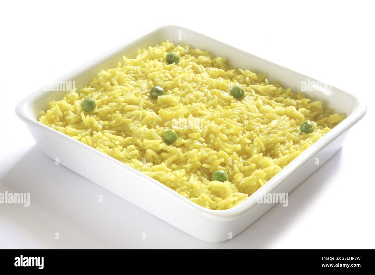 Indian cuisine khichdi garnish green peas served in deep plate on white ...