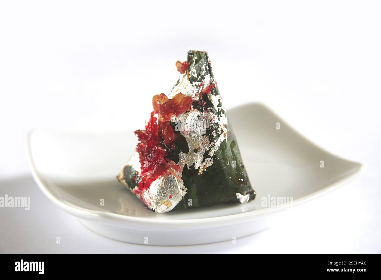 Gilouri pan prepared and folded in betel leaves serve in plate on white ...