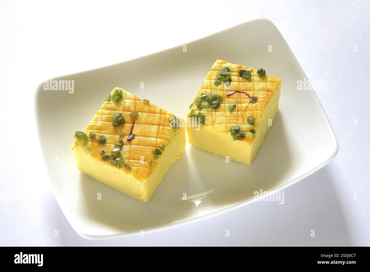 Indian sweet, sandesh bengali mithai garnish with pistachio and saffron ...