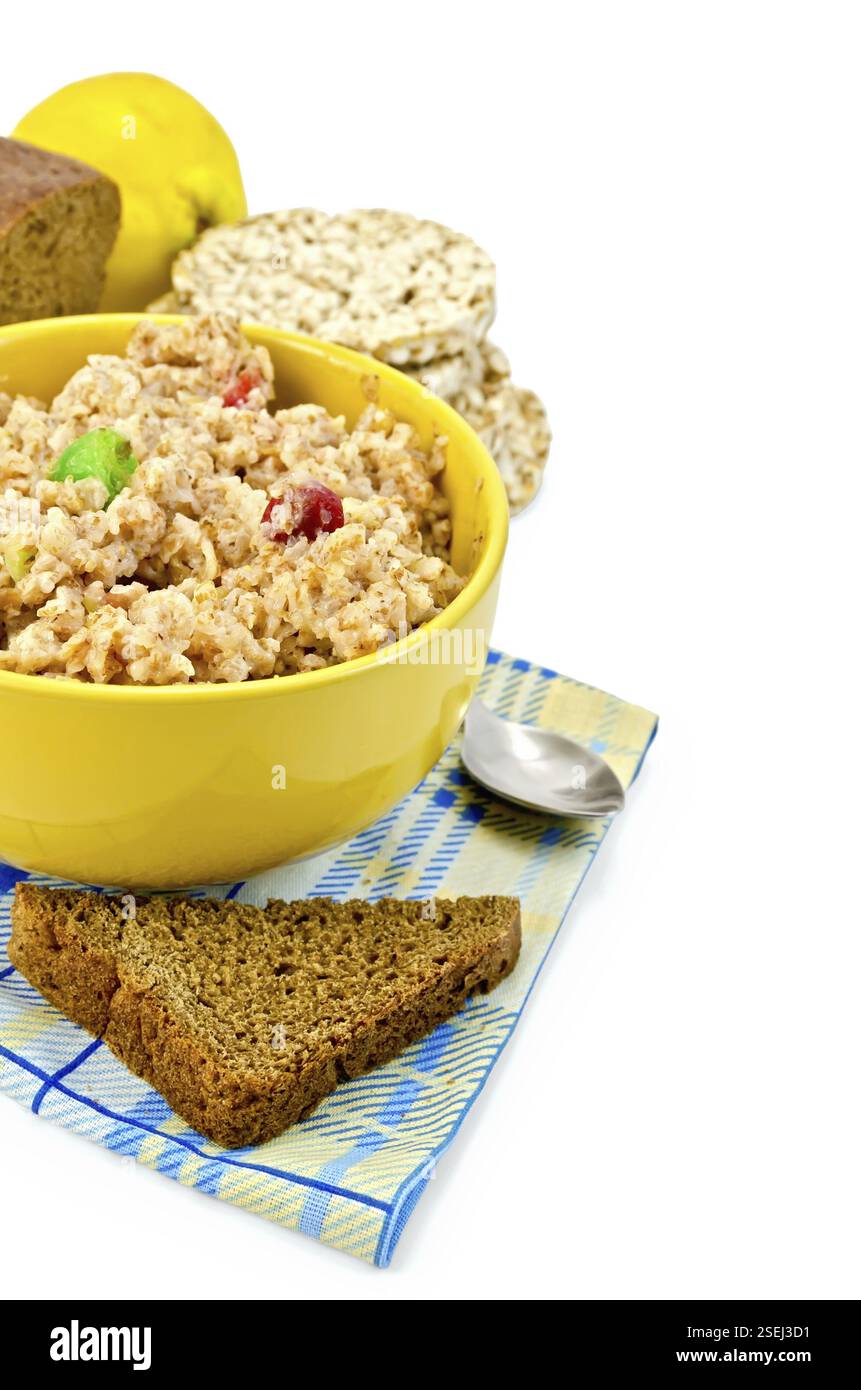 Porridge rye flakes with candied fruit, dark rye bread, spoon on a ...