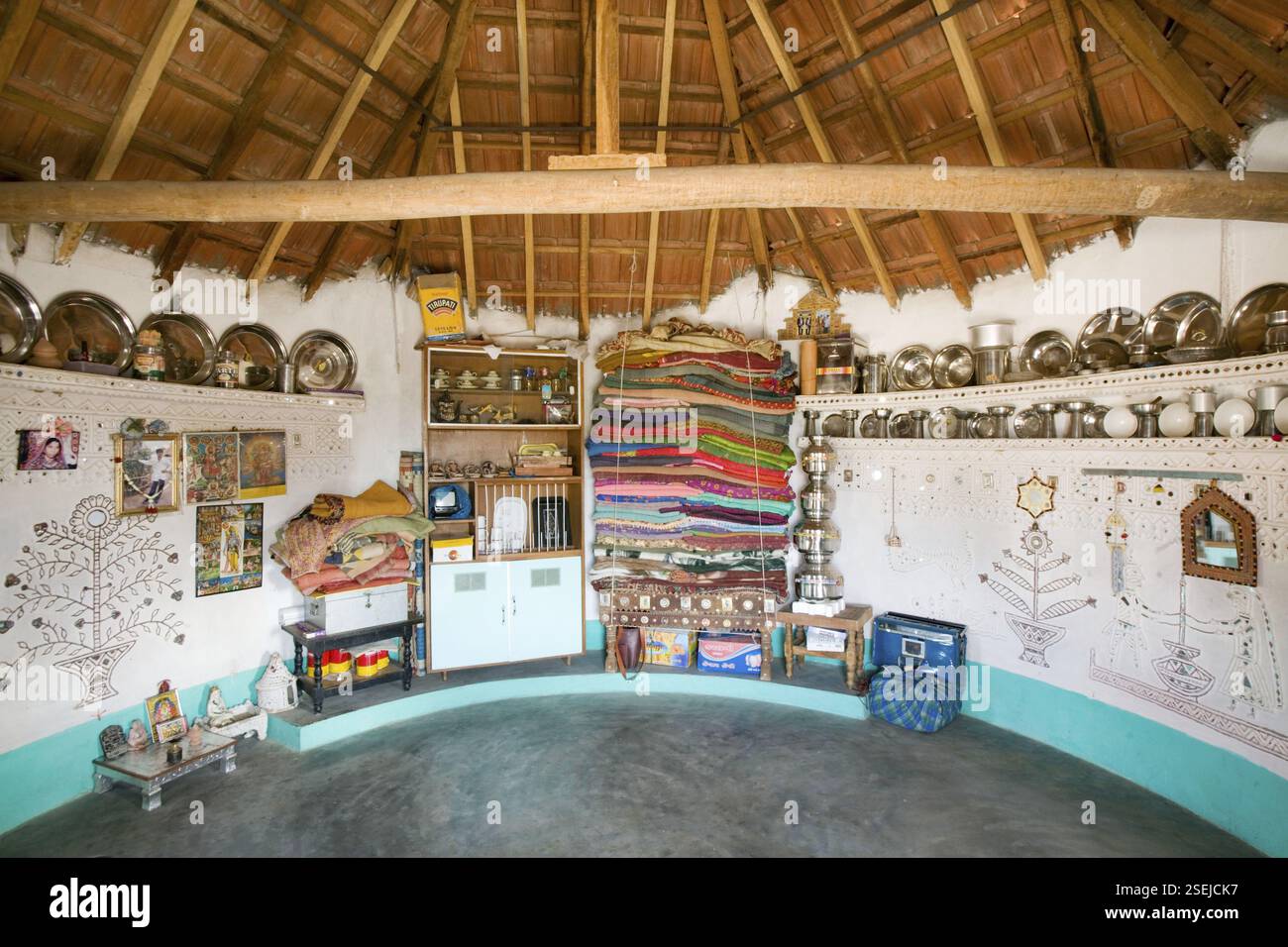 Interior of bhunga circular house with household utilities placed at ...